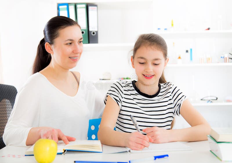 Mother Helping Daughter with Homework Stock Photo - Image of attentive ...