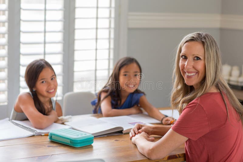 Mother Helping Her Daughters with Their Homework Stock Image - Image of ...