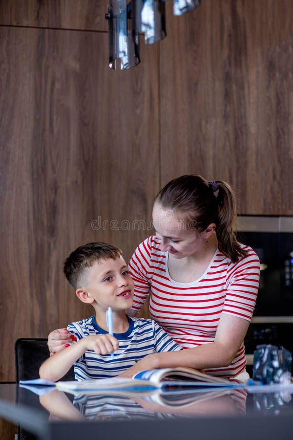 Mother Helping Her Son Doing Homework in Kitchen Stock Image - Image of bonding, table: 361302275