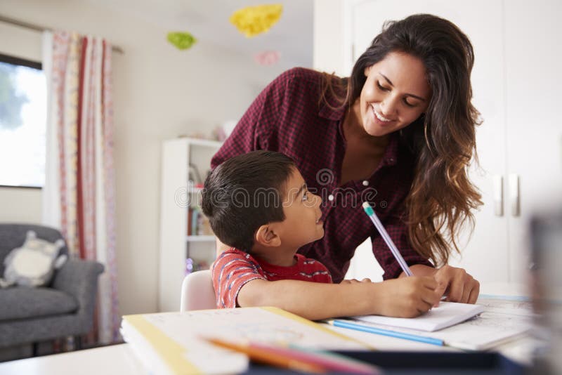 Mother Helping Son with Homework Sitting at Desk in Bedroom Stock Photo ... Mother Helping Son with Homework Sitting at Desk in Bedroom Stock Photo ...