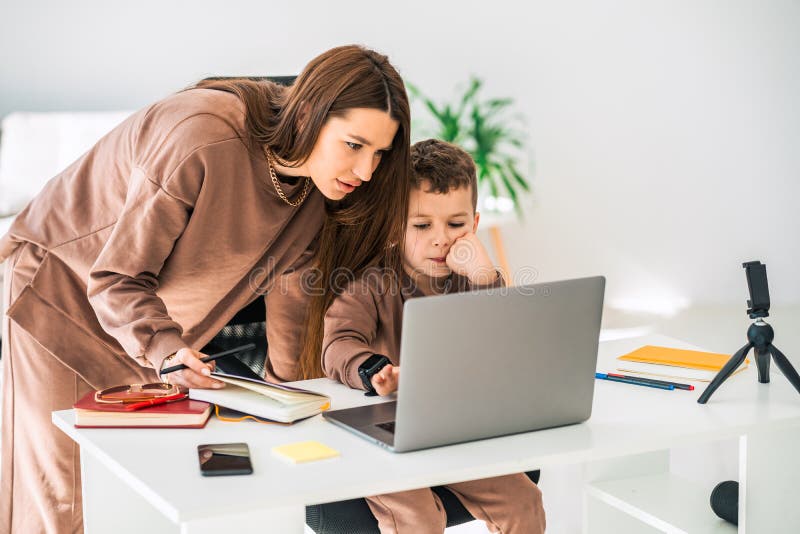 Mother Helps Her Son with Online Distance Education. Stock Photo ... Mother Helps Her Son with Online Distance Education. Stock Photo ...