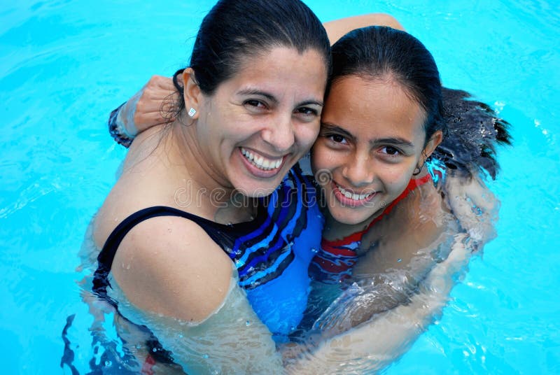 Mother Hugging Her Daughter in the Pool. Stock Image - Image of ...