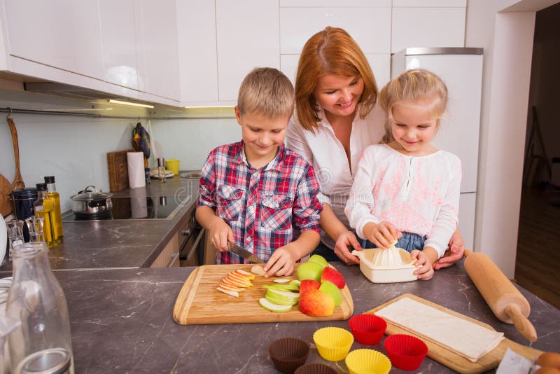 Mother and Her Children Preparing Food Stock Photo - Image of dinner ...