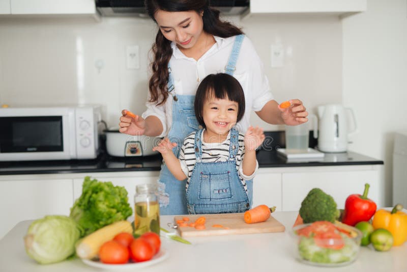Mother with Her Daughter in the Kitchen Cooking Together Stock Image ...