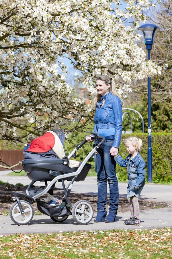 Mother and Her Daughter with a Pram Stock Photo - Image of blonde ...