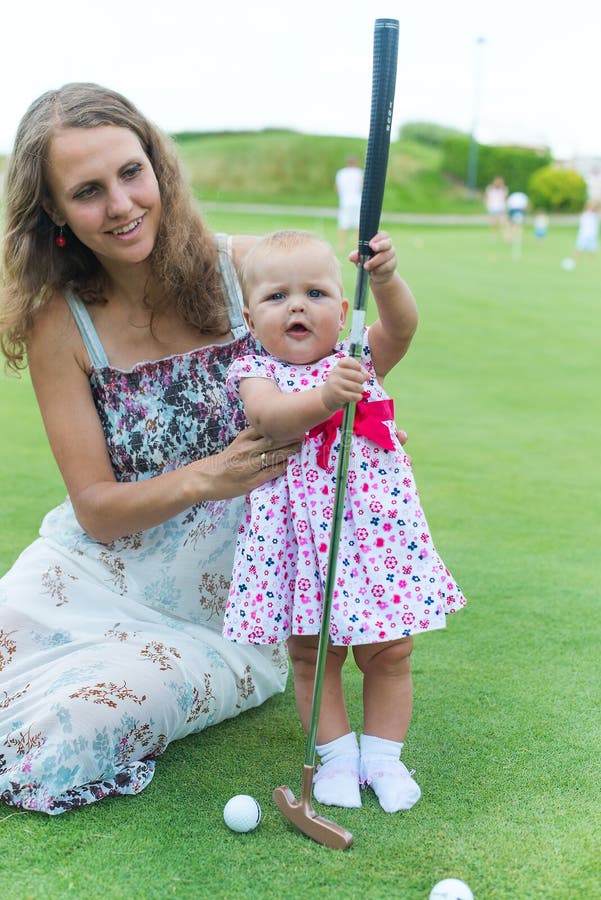 Mother and Her Little Daughter Practicing To Hit the Ball Stock Photo ...