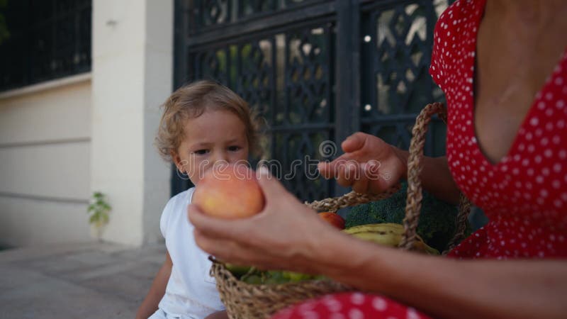 Mother And Her Son With A Basket Of Fruits And Vegetables From Farmers