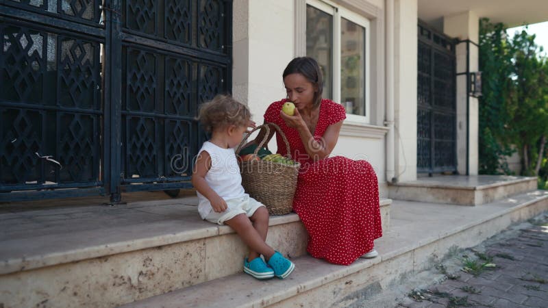 Mother And Her Son With A Basket Of Fruits And Vegetables From Farmers