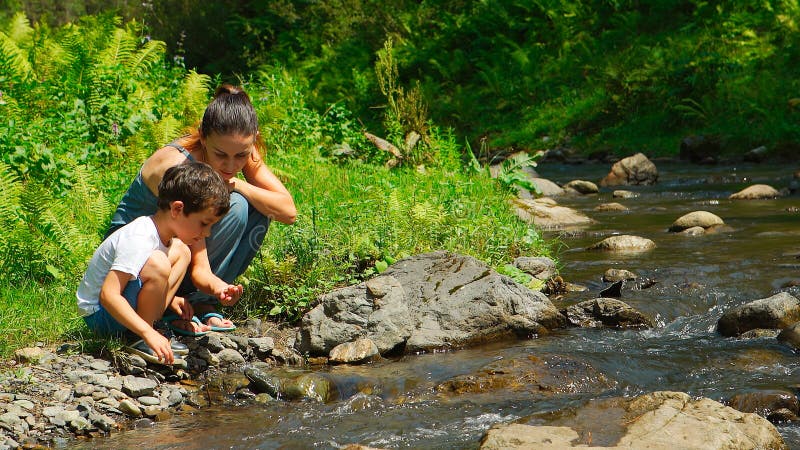 Mother with Her Son are Sitting Near a Stream Stock Photo - Image of ...