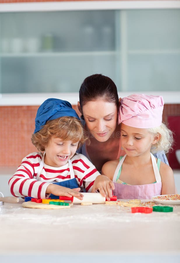 Mother Interacting with Children in Kitchen Stock Photo - Image of copy ...
