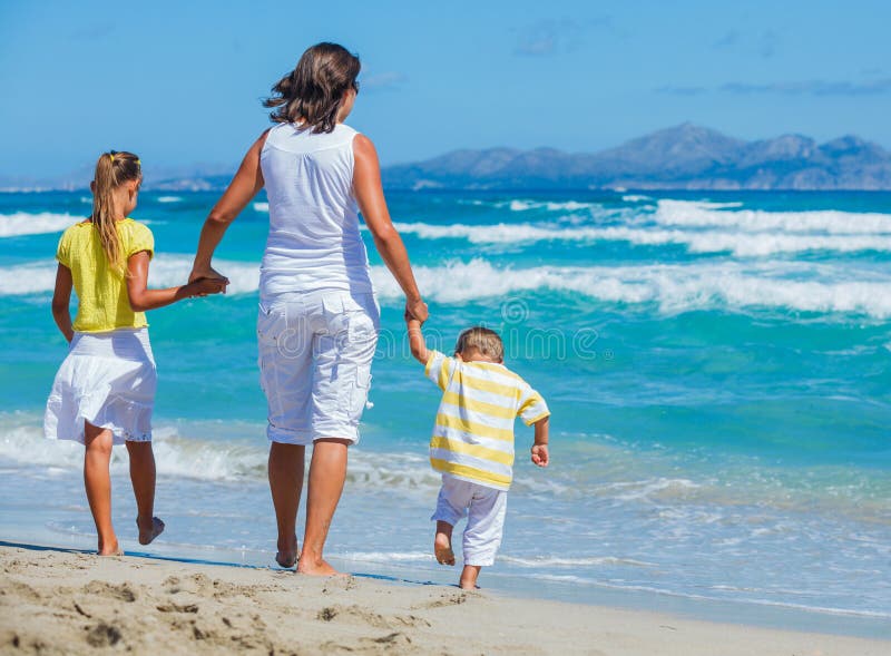 Mother with kids on beach stock photo. Image of seaside - 54101210