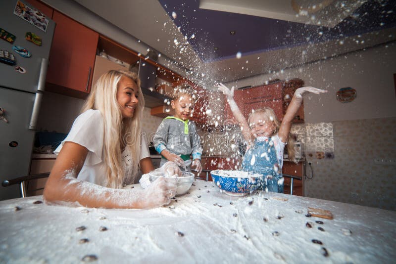 Mother with Kids on Kitchen Throwing Flour To the Top Stock Image ...
