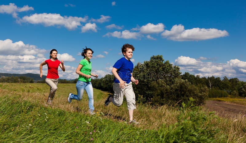 Family Running on a Dirt Road Stock Photo - Image of group, grass: 43607680