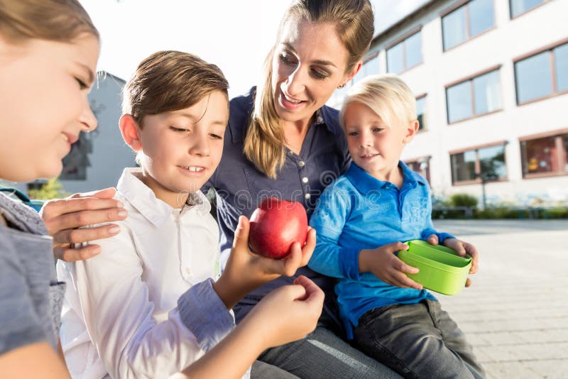 Mother and Kids at School Having Breaktime with Apple and Lunchb Stock ...