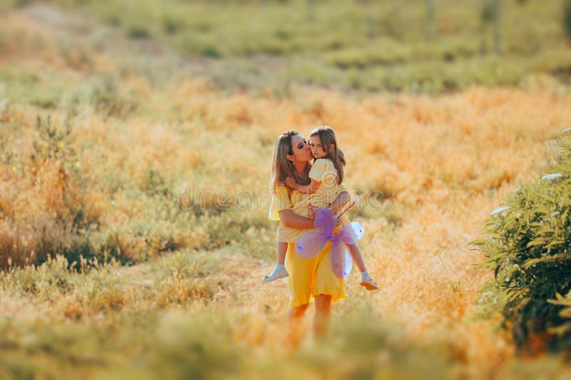 Mother Kissing And Holding Her Daughter Outdoors Stock Image Image Of