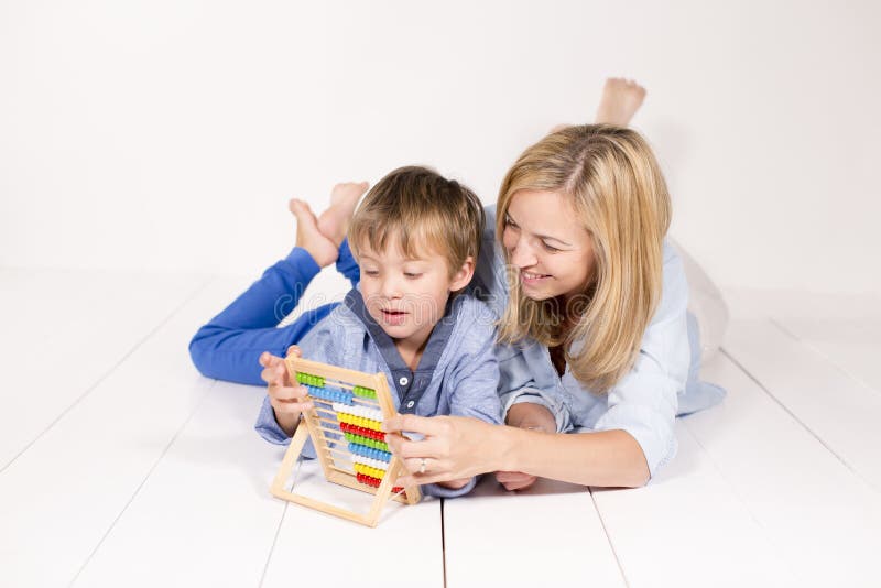 Mother Learns To Calculate with Son on a White Floor Stock Image ...