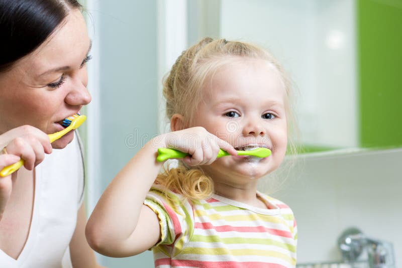 Mother and Little Daughter Brushing Teeth in Bathroom Stock Image ...