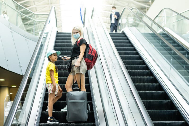 Mother and Little Daughter Go with Suitcases To the Airport. Tourism ... Mother and Little Daughter Go with Suitcases To the Airport. Tourism ...