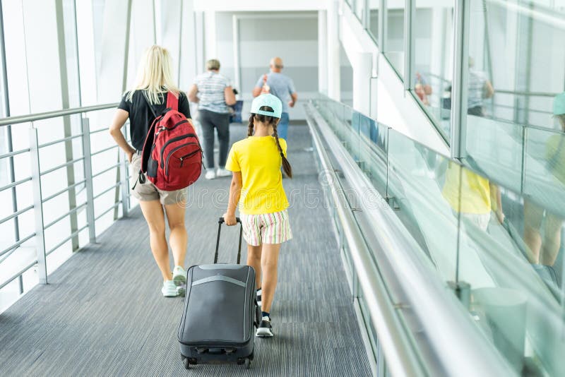 Mother and Little Daughter Go with Suitcases To the Airport. Tourism ... Mother and Little Daughter Go with Suitcases To the Airport. Tourism ...