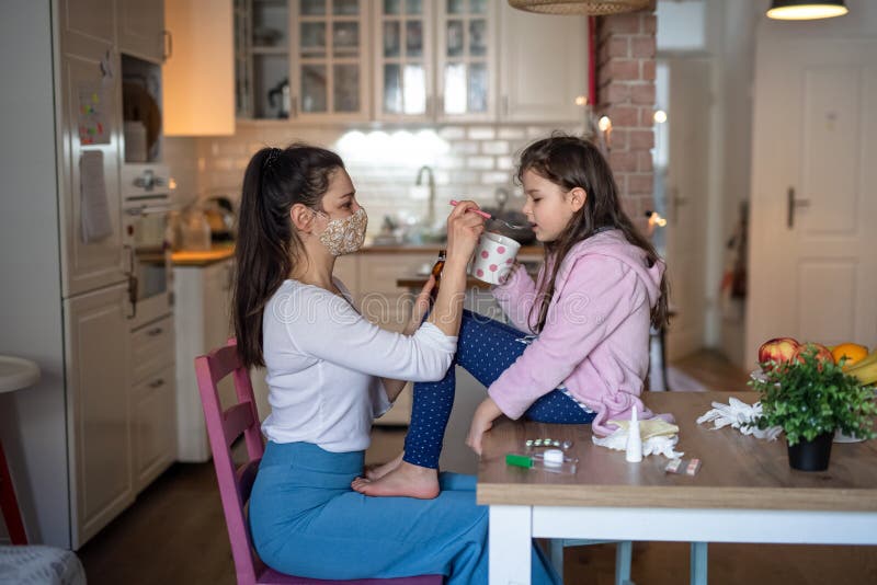 Mother Looking after Sick Small Daughter at Home. Stock Photo - Image ...
