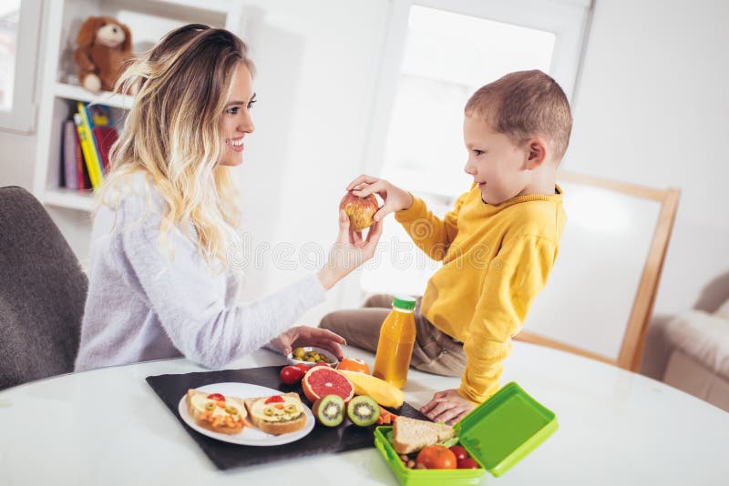 Mother Making Breakfast for Her Children in the Morning and a Snack ...