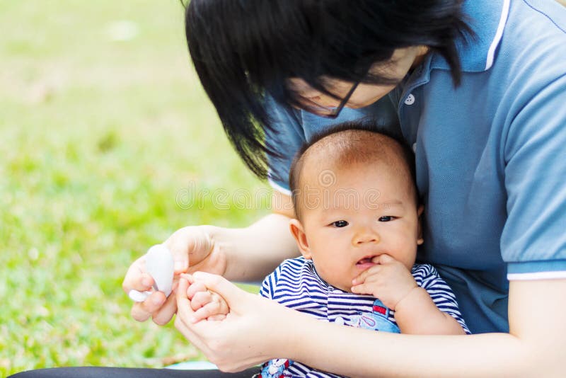 Mother Parenting Baby on Park Stock Photo - Image of summer, female ...