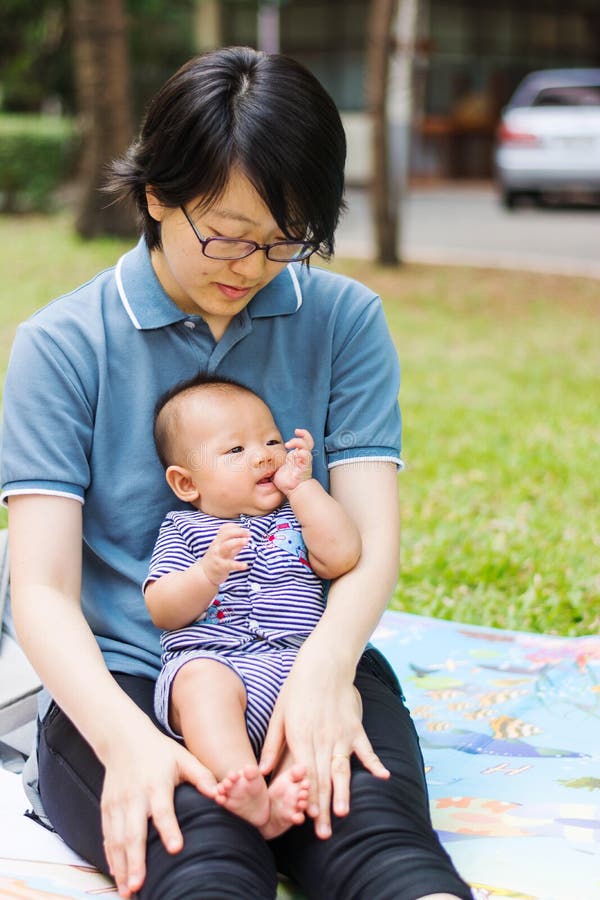 Mother Parenting Baby on Park Stock Image - Image of outside, family ...
