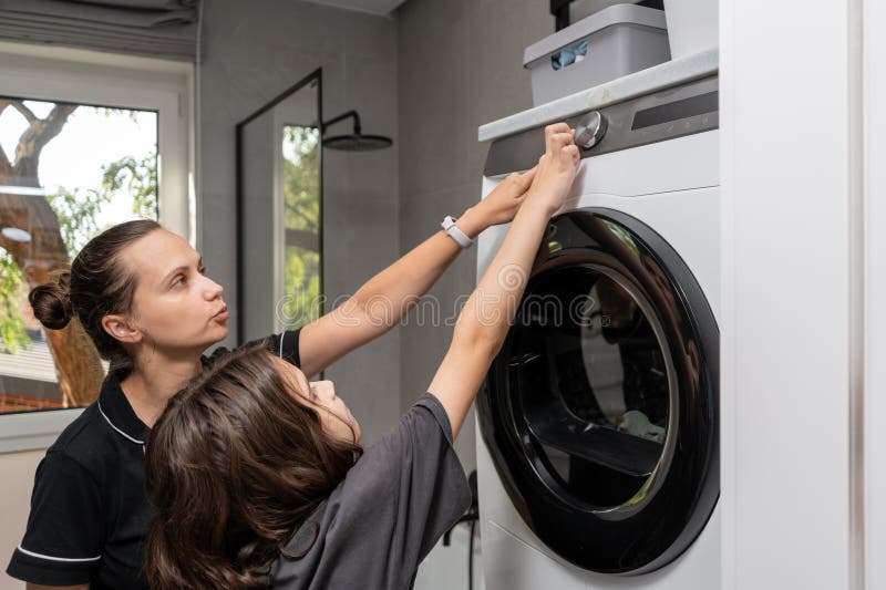 Family Laundry: Child Learning To Operate Dryer with Mother S Help ...