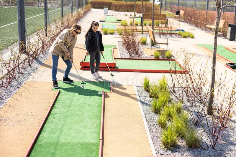 Mother Playing with Her Cute Daughter in Mini Golf Stock Image - Image ...