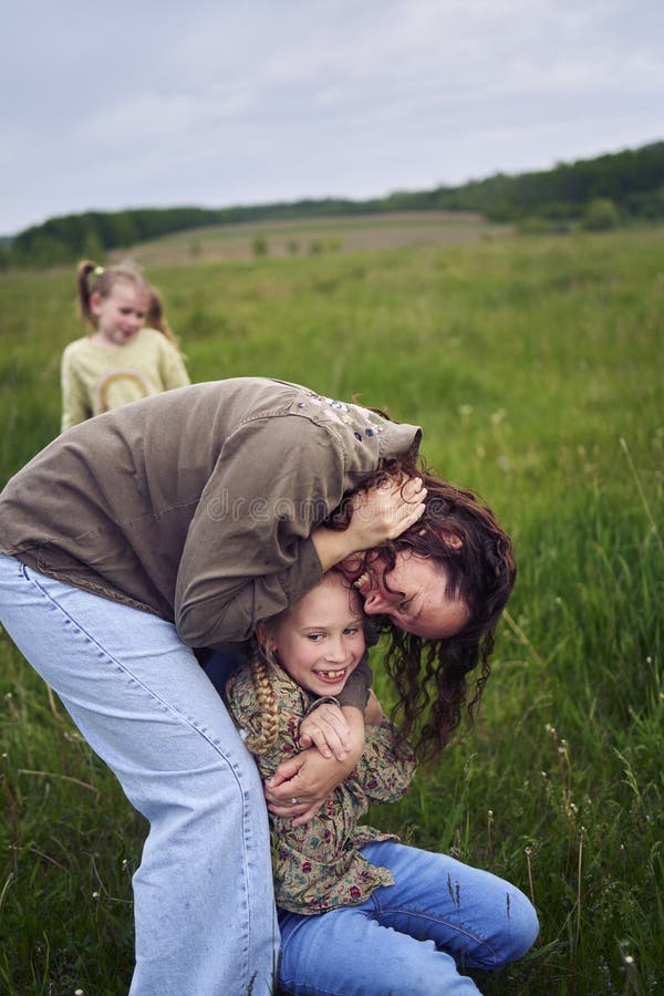 Mother Plays Catch Up with Her Daughters Stock Photo - Image of ...