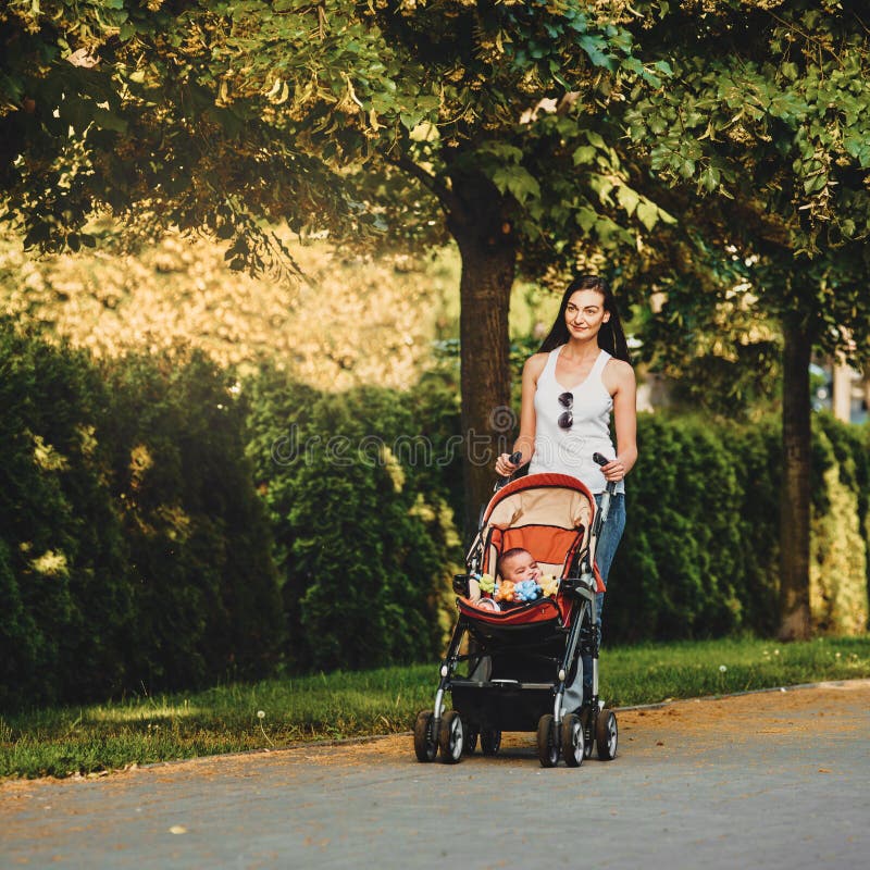 Mother with pram in park stock image. Image of parenthood - 159135003