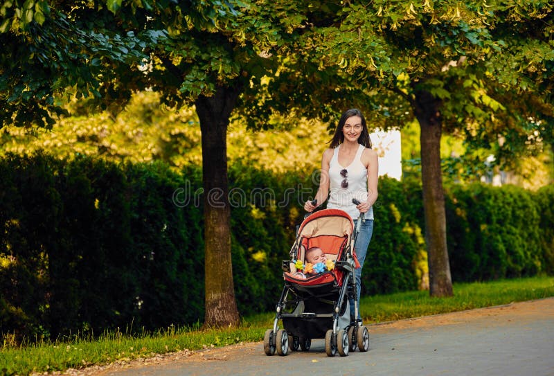 Mother with pram in park stock image. Image of parenthood - 159135003