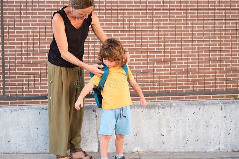 Mother Putting Her Child S Backpack on before Going To School. Stock ...