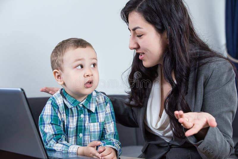 Mother Questioning Her Little Boy while Using Laptop Stock Photo ...
