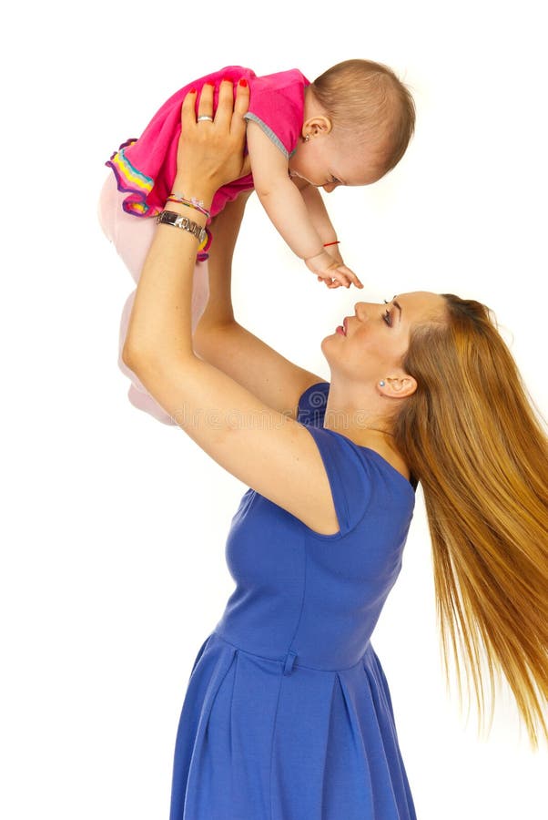 Mother raising baby girl stock image. Image of person - 24307751