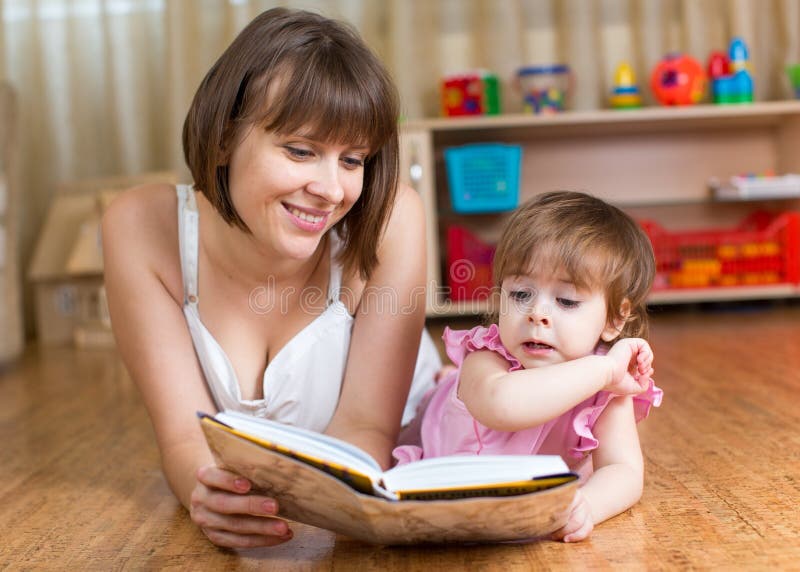 Mother Reading a Book To Kid Stock Photo - Image of looking, attractive ...