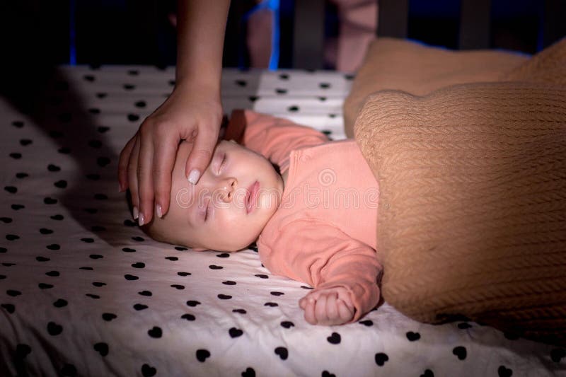 Mother S Hand Caresses the Baby Forehead Who is Sleeping with a ...