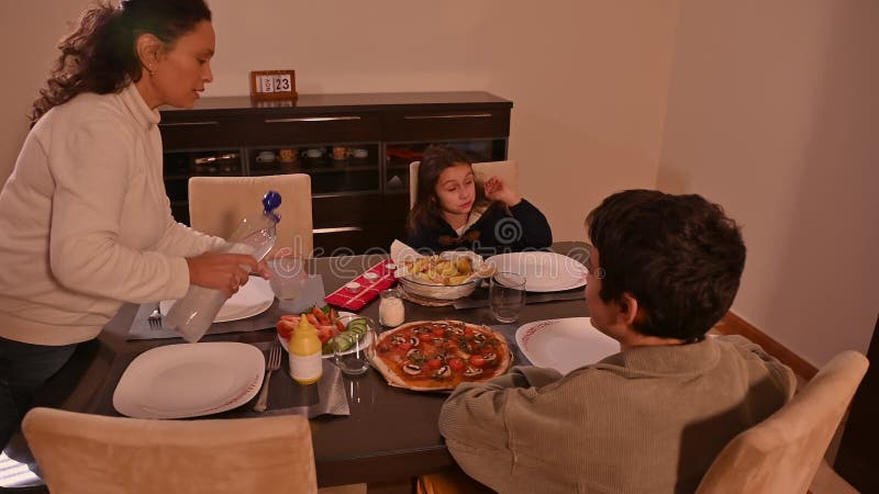 Happy Family Dinner with Mother Serving Food To Smiling Children at the ...