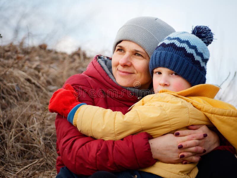 Mother with a Small Son Cuddles in Nature in Autumn Stock Photo - Image ...