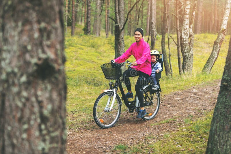 Mother with Son in Bike Child Seat Cycling on Forest Trail Stock Image ... Mother with Son in Bike Child Seat Cycling on Forest Trail Stock Image ...