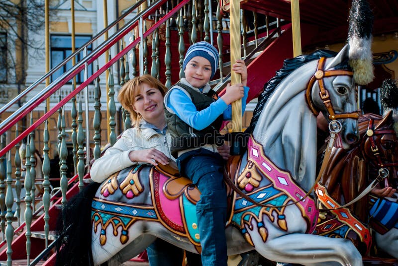 Mother and son on carousel stock image. Image of autumn - 54255521
