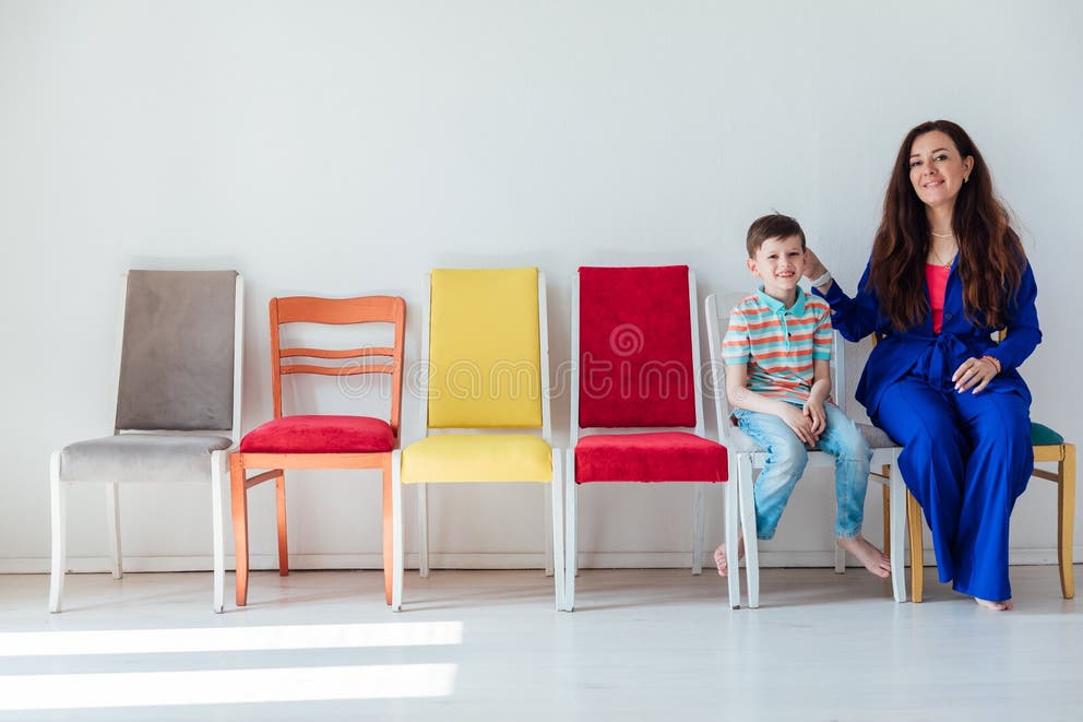 Mother and Son on Chairs in the Interior of a White Room Stock Image ...