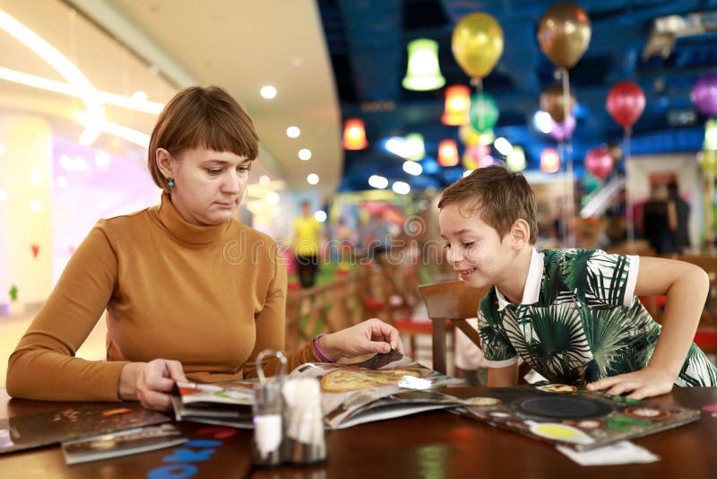 Mother with Son Choosing Dish in Menu Stock Photo - Image of leisure ...