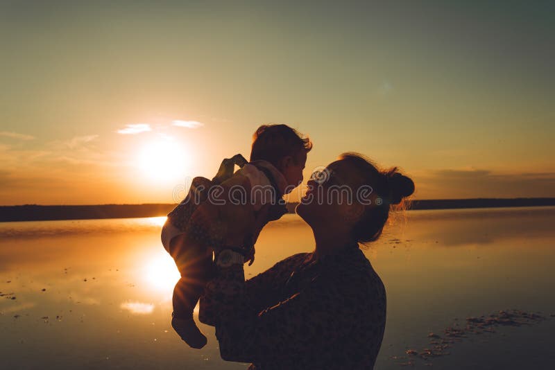 Mother with Son Enjoying Sunset on the Beach Stock Photo - Image of ...