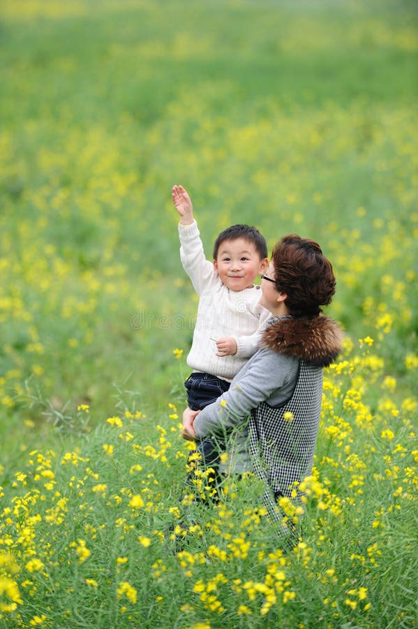 Mother and son in flowers stock photo. Image of beautiful - 13976014