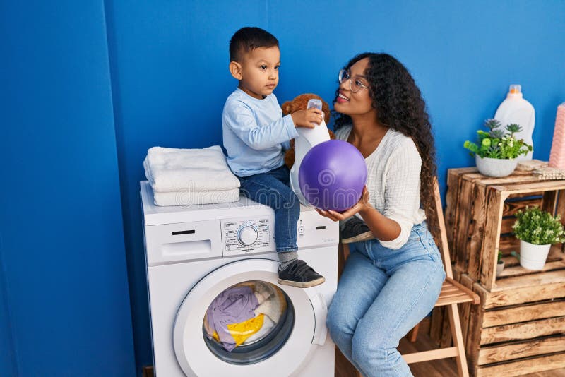 Mother and Son Playing with Ball Waiting for Washing Machine at Laundry ...