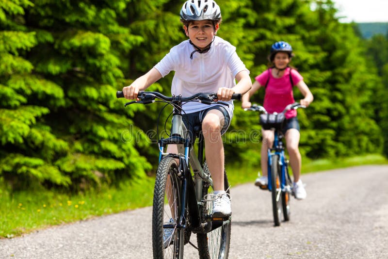 Happy Kids riding bikes stock photo. Image of energy - 22095492