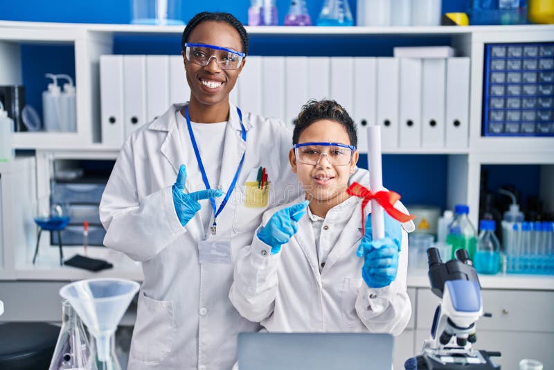 Mother and Son at Scientist Laboratory Smiling Happy Pointing with Hand ...