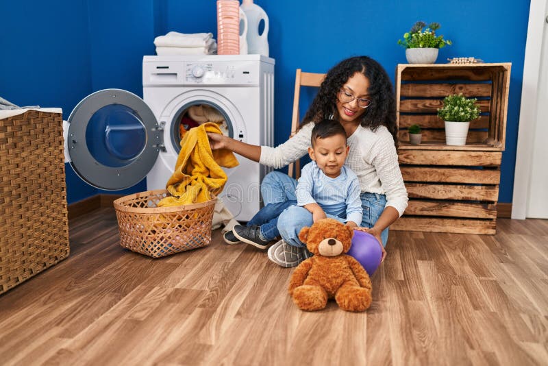 Mother and Son Smiling Confident Washing Clothes at Laundry Room Stock ...