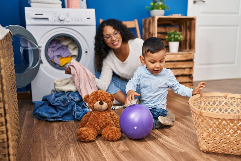 Mother and Son Smiling Confident Washing Clothes at Laundry Room Stock ...